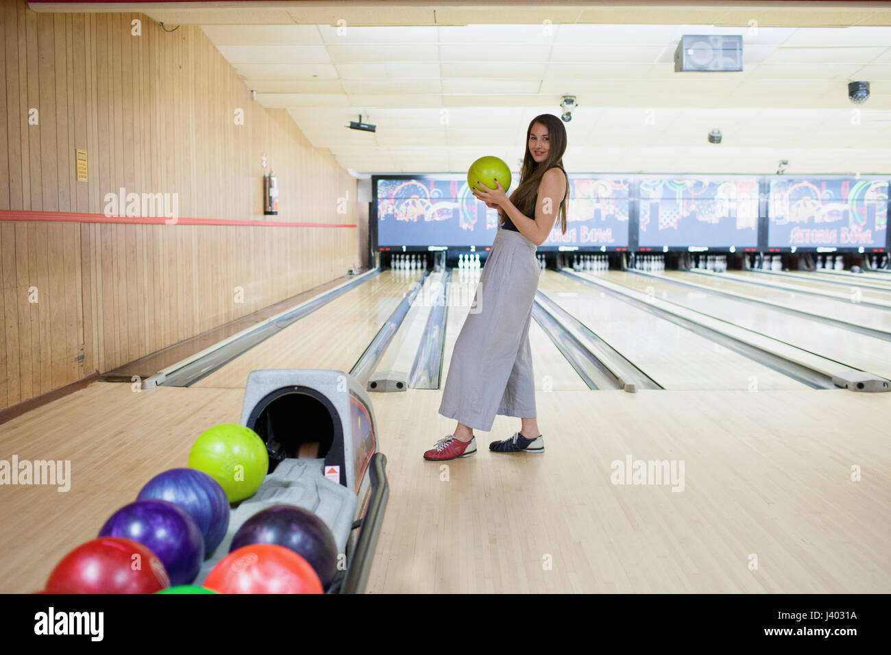 A young woman bowling Stock Photo - Alamy
