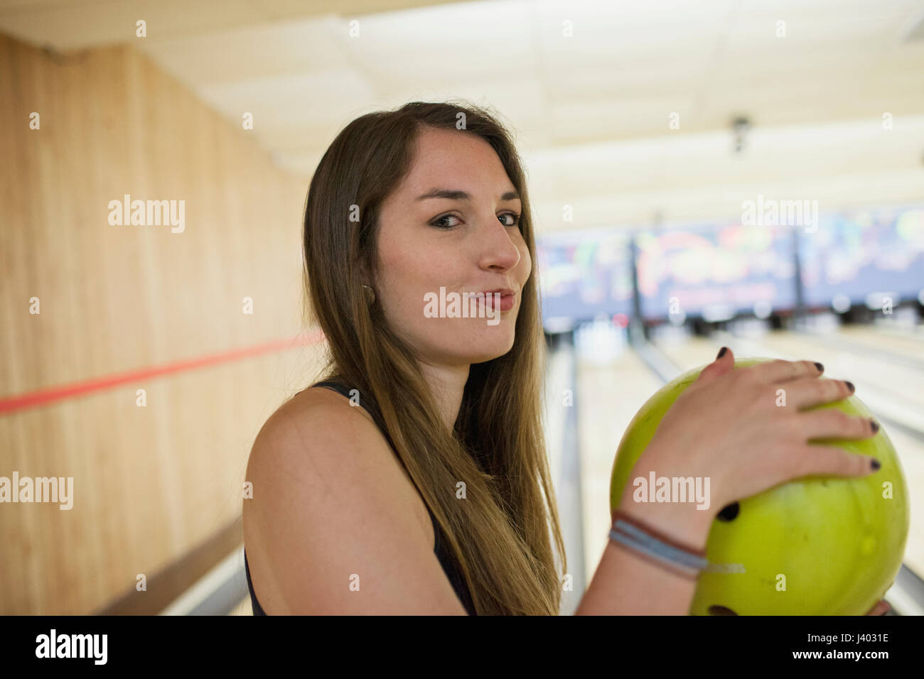 A young woman with a bowling ball Stock Photo - Alamy