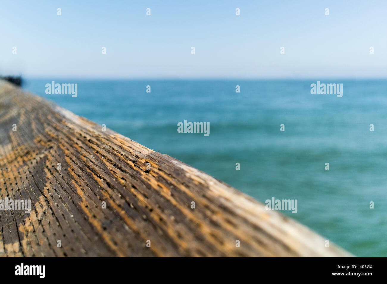 Weathered wood rail on a blue sky Stock Photo - Alamy