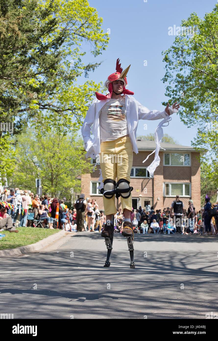 A man bouncing with spring shoes at the Mayday parade in Minneapolis ...
