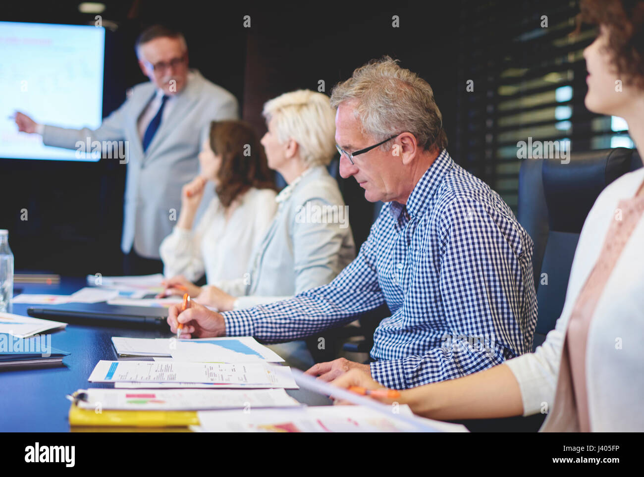 Group of business people sitting at conference table Stock Photo - Alamy