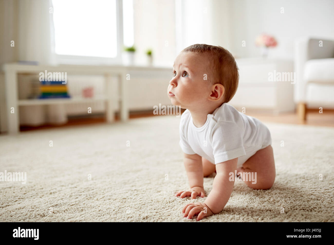 little baby in diaper crawling on floor at home Stock Photo - Alamy