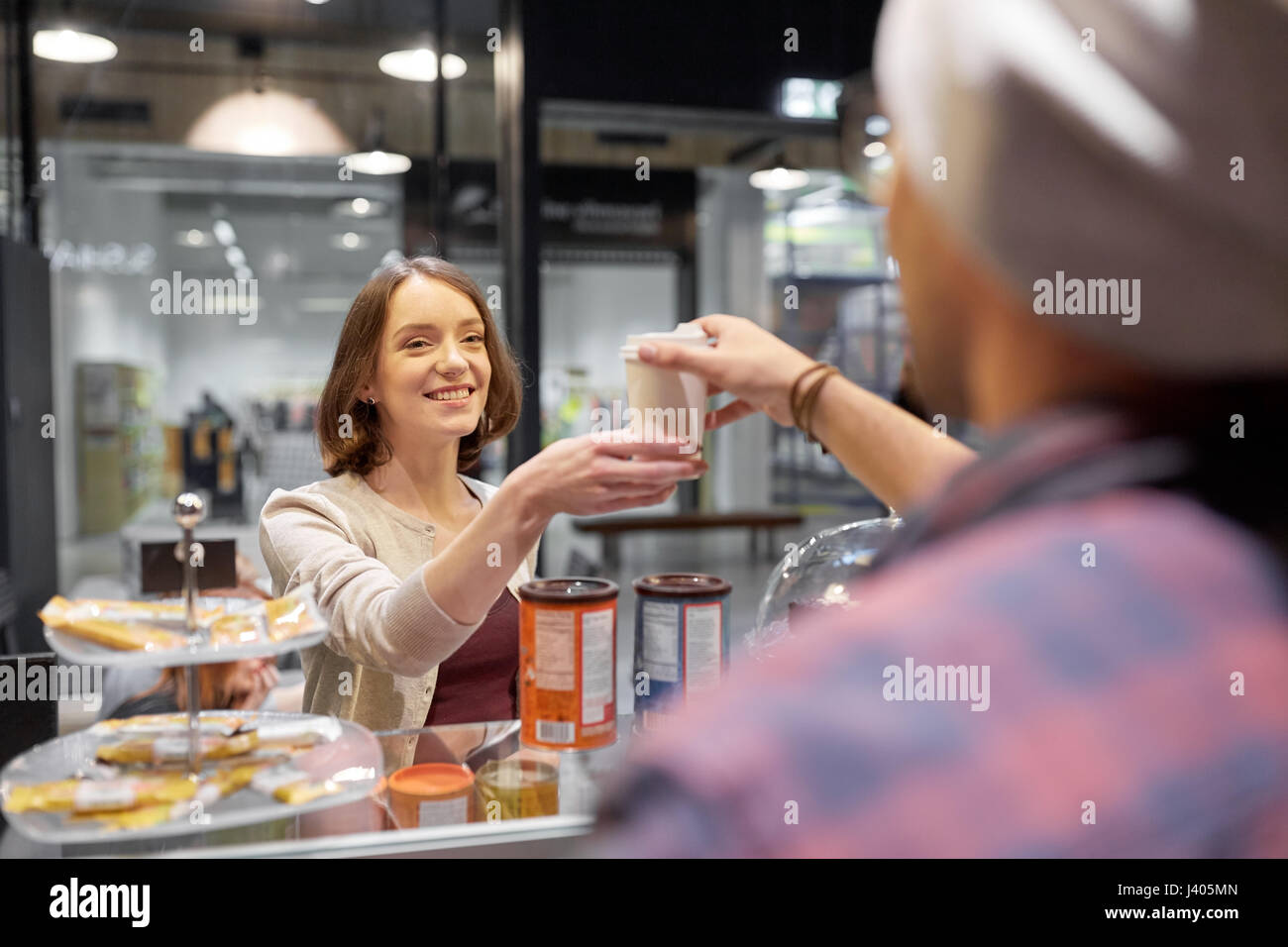 happy woman taking coffee cup from seller at cafe Stock Photo - Alamy