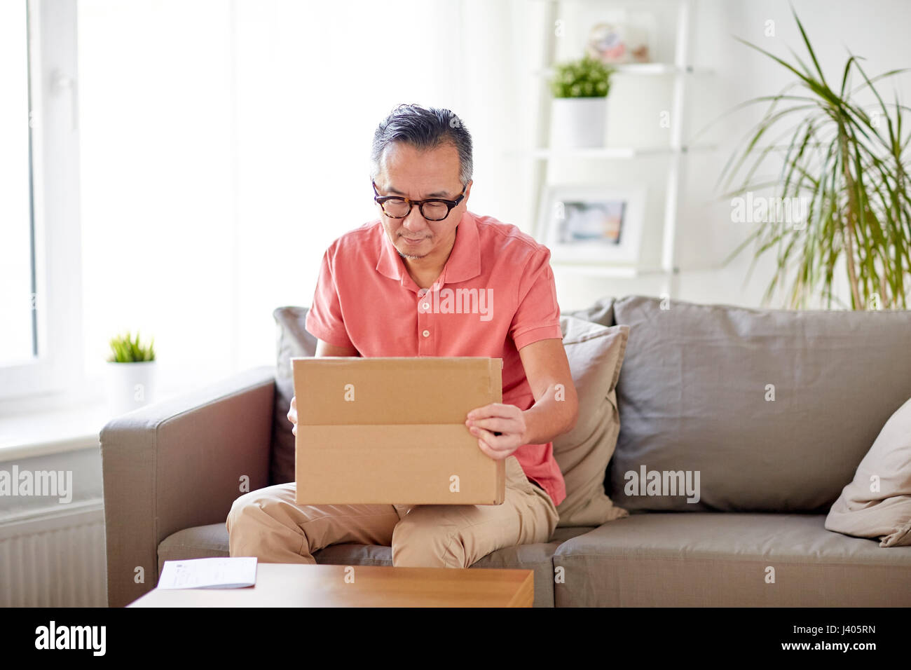 man opening parcel box at home Stock Photo - Alamy