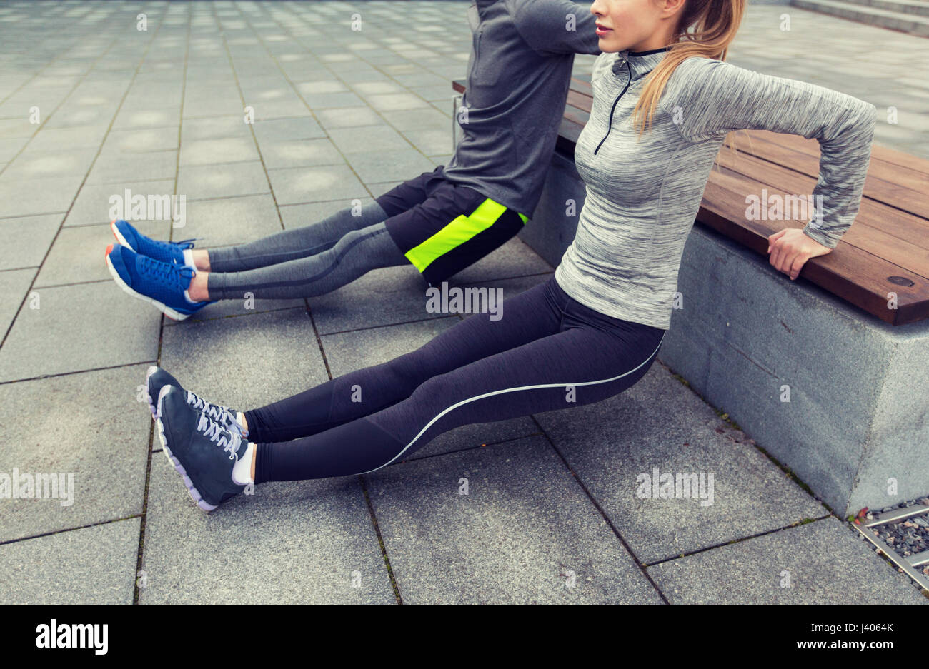 close up of couple doing triceps dip on bench Stock Photo - Alamy