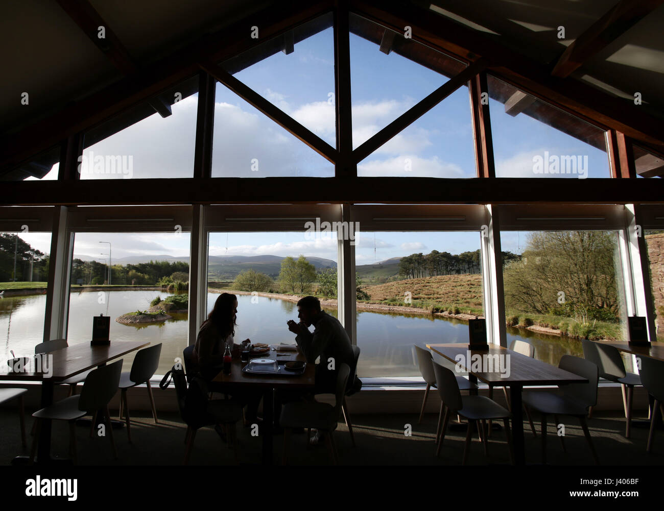 People having breakfast against a scenic backdrop at Tebay motorway ...
