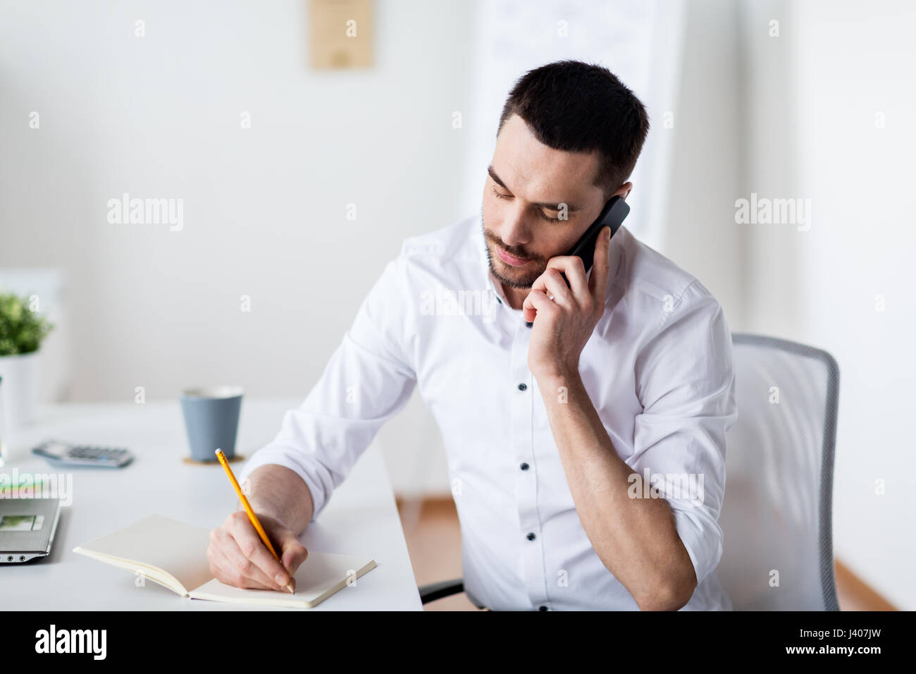 businessman calling on smartphone at office Stock Photo - Alamy