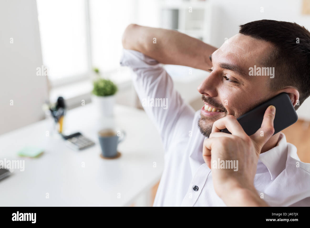 businessman calling on smartphone at office Stock Photo - Alamy