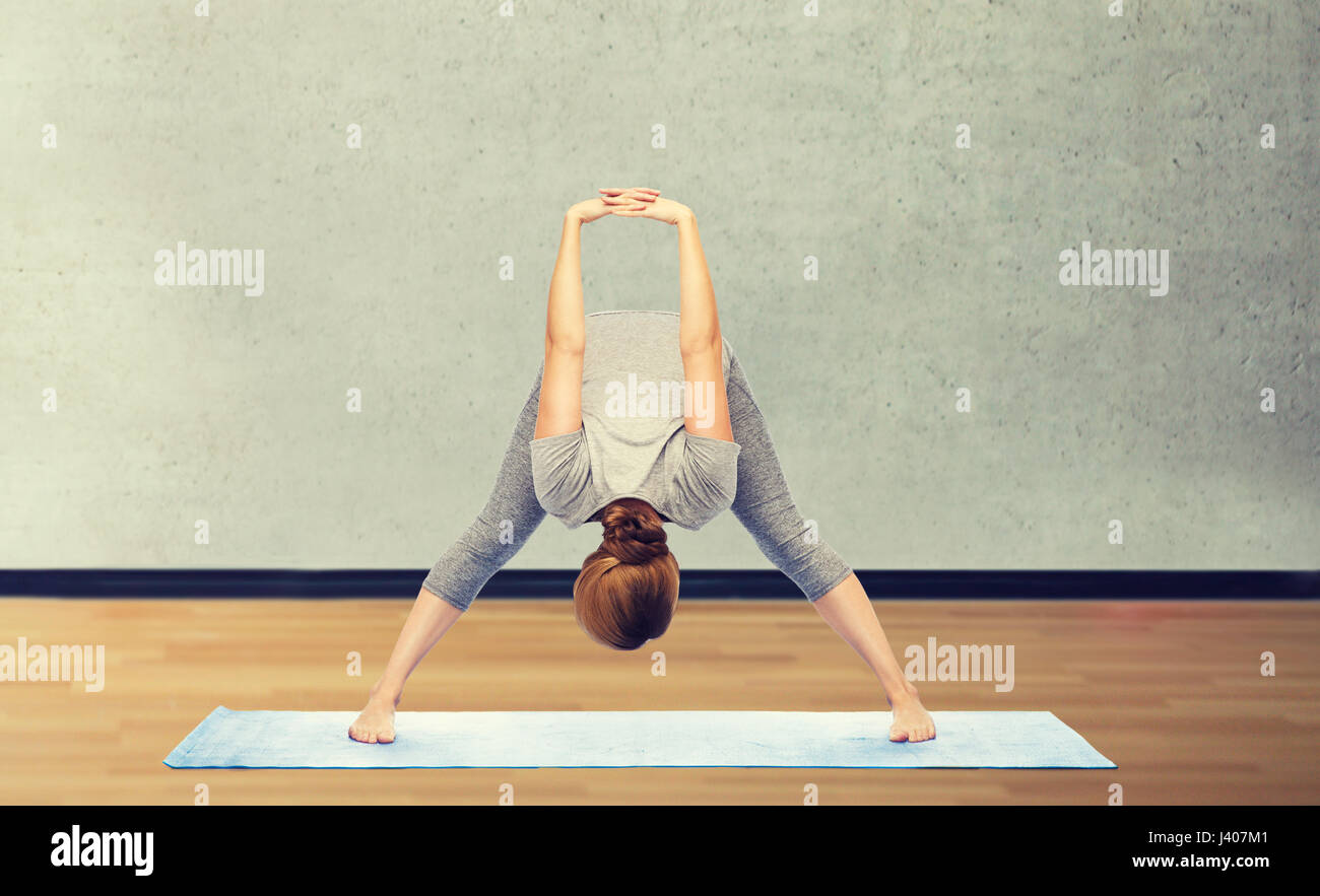 woman making yoga in wide-legged forward bend pose Stock Photo - Alamy