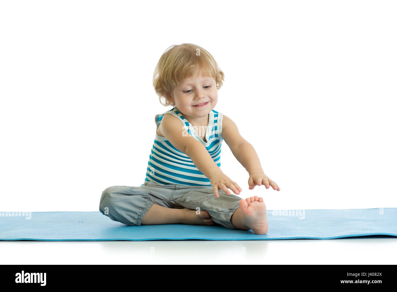 Kid child doing a set of exercises for stretching Stock Photo - Alamy