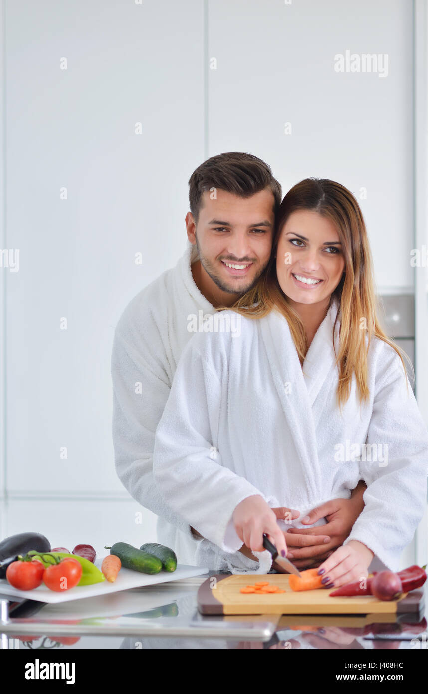 Happy couple cooking breakfast together in the kitchen Stock Photo - Alamy