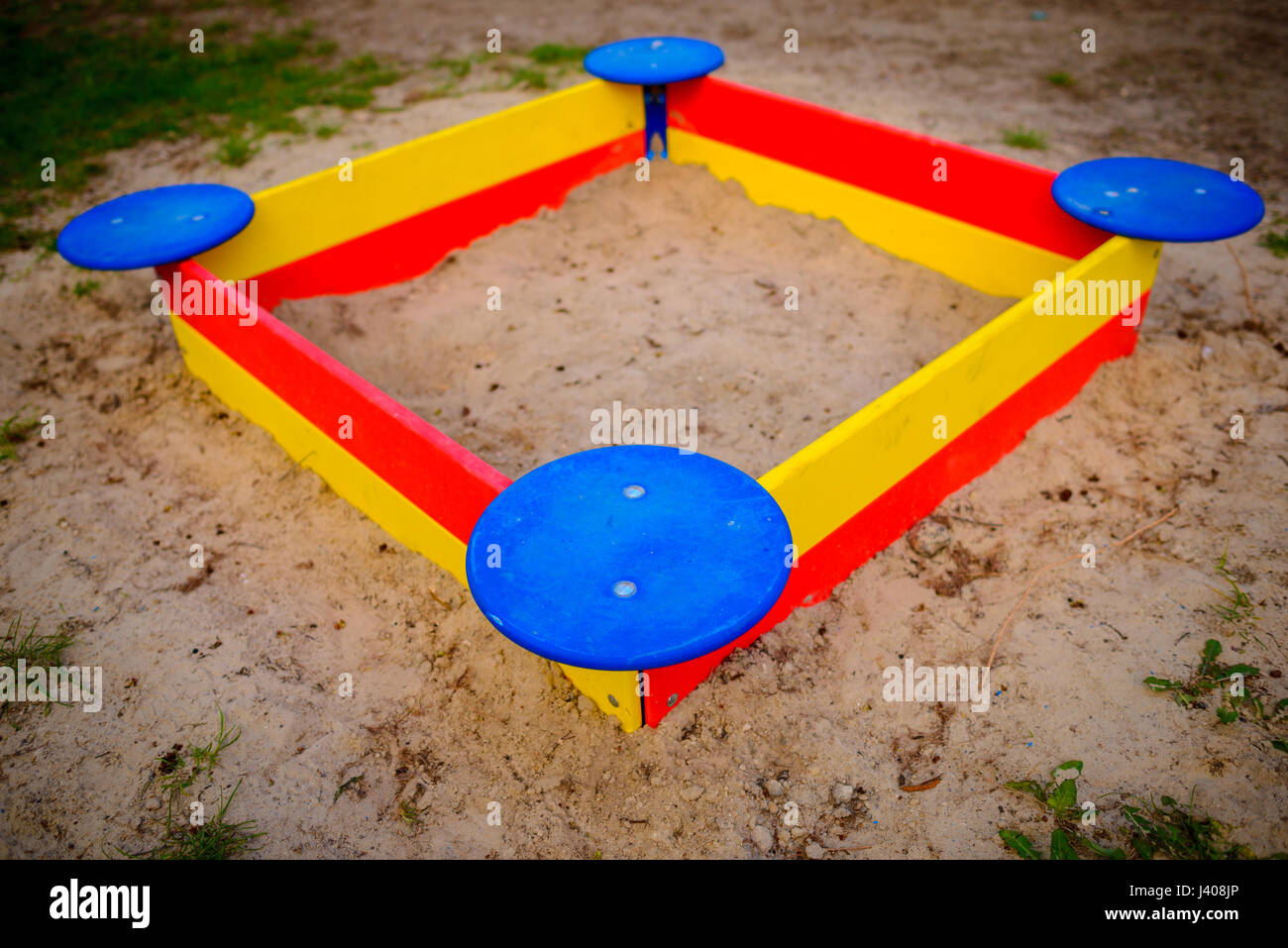 A nice sandbox playground filled . Surrounded by green grass, seen from ...