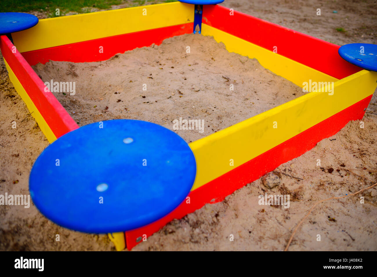 A nice sandbox playground filled . Surrounded by green grass, seen from ...