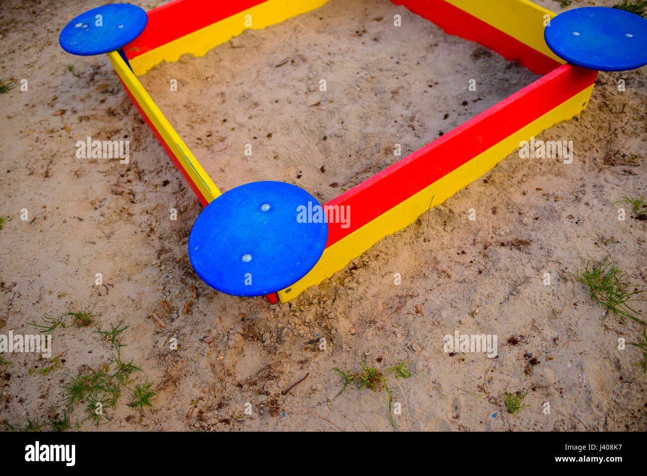 A nice sandbox playground filled . Surrounded by green grass, seen from ...