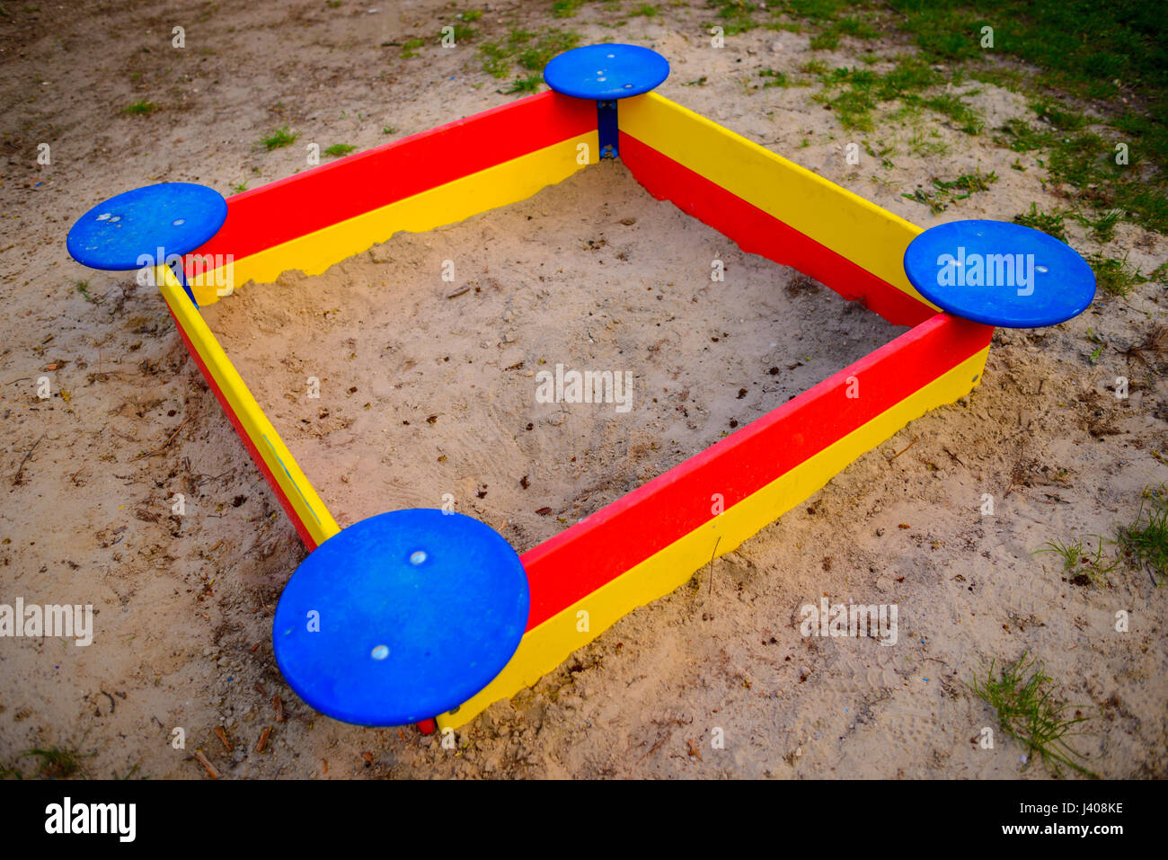 A nice sandbox playground filled . Surrounded by green grass, seen from ...