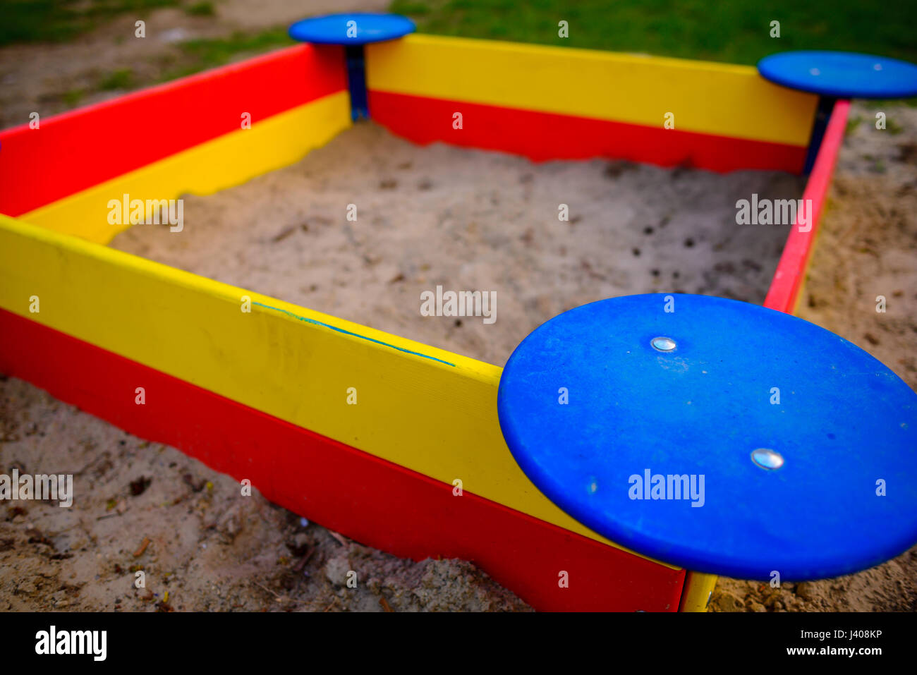 A nice sandbox playground filled . Surrounded by green grass, seen from ...