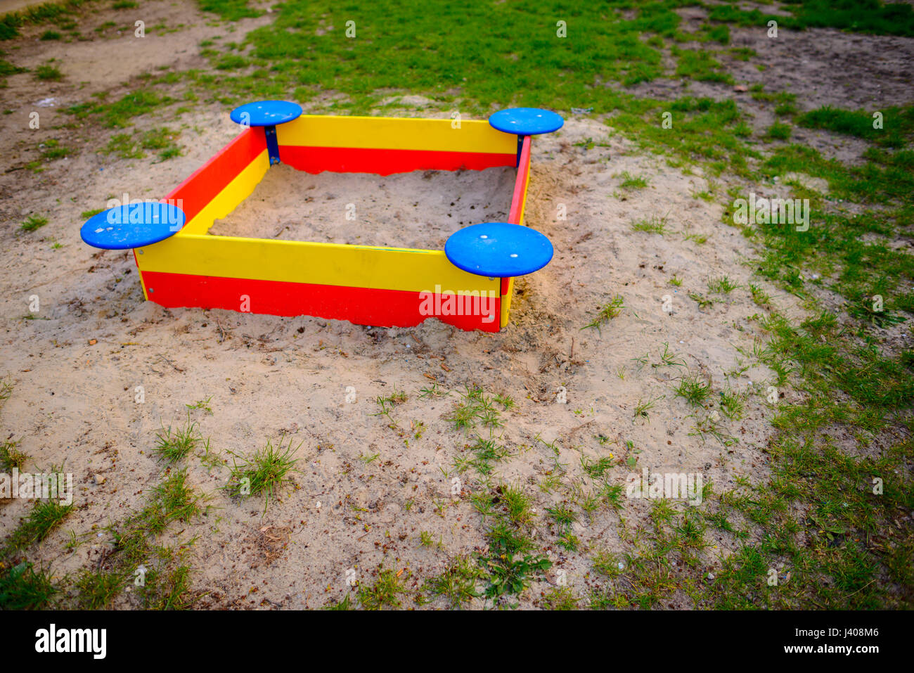 A nice sandbox playground filled . Surrounded by green grass, seen from ...