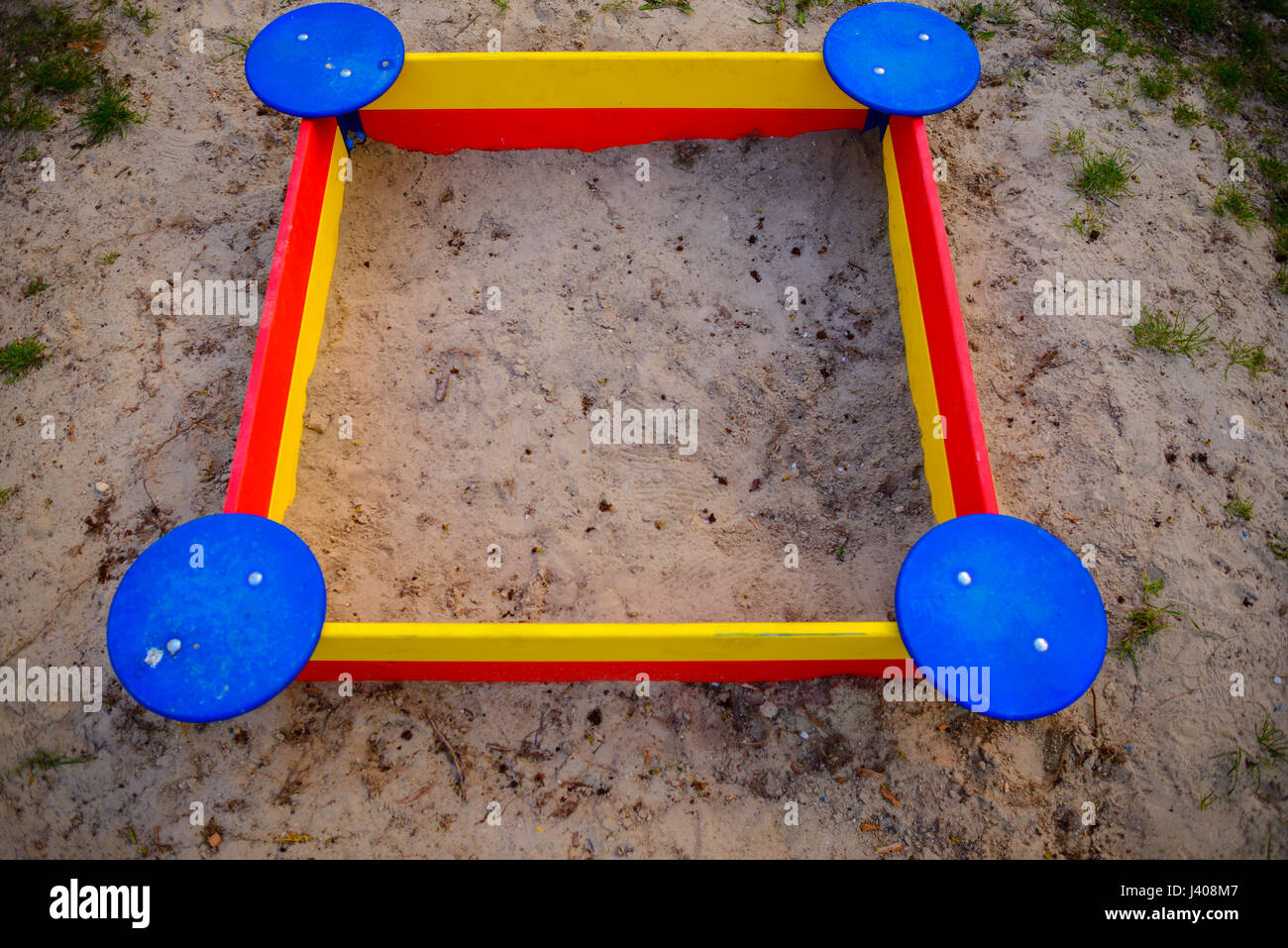 A nice sandbox playground filled . Surrounded by green grass, seen from ...