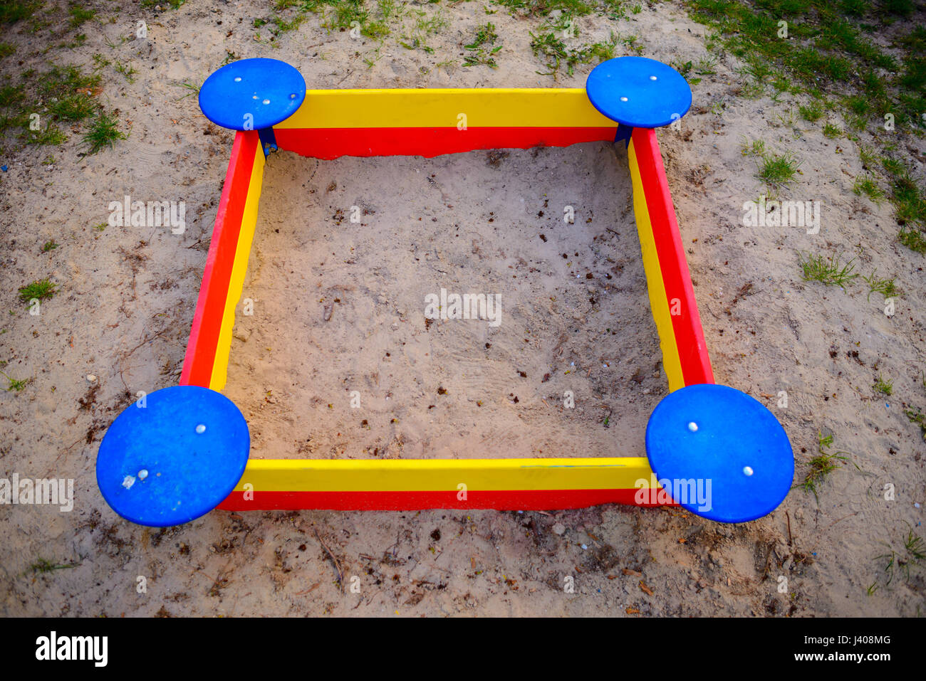 A nice sandbox playground filled . Surrounded by green grass, seen from ...