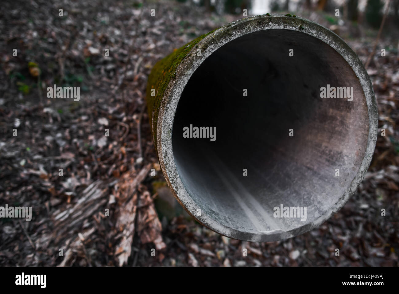 sewage pipe acts on the ground, background Stock Photo - Alamy