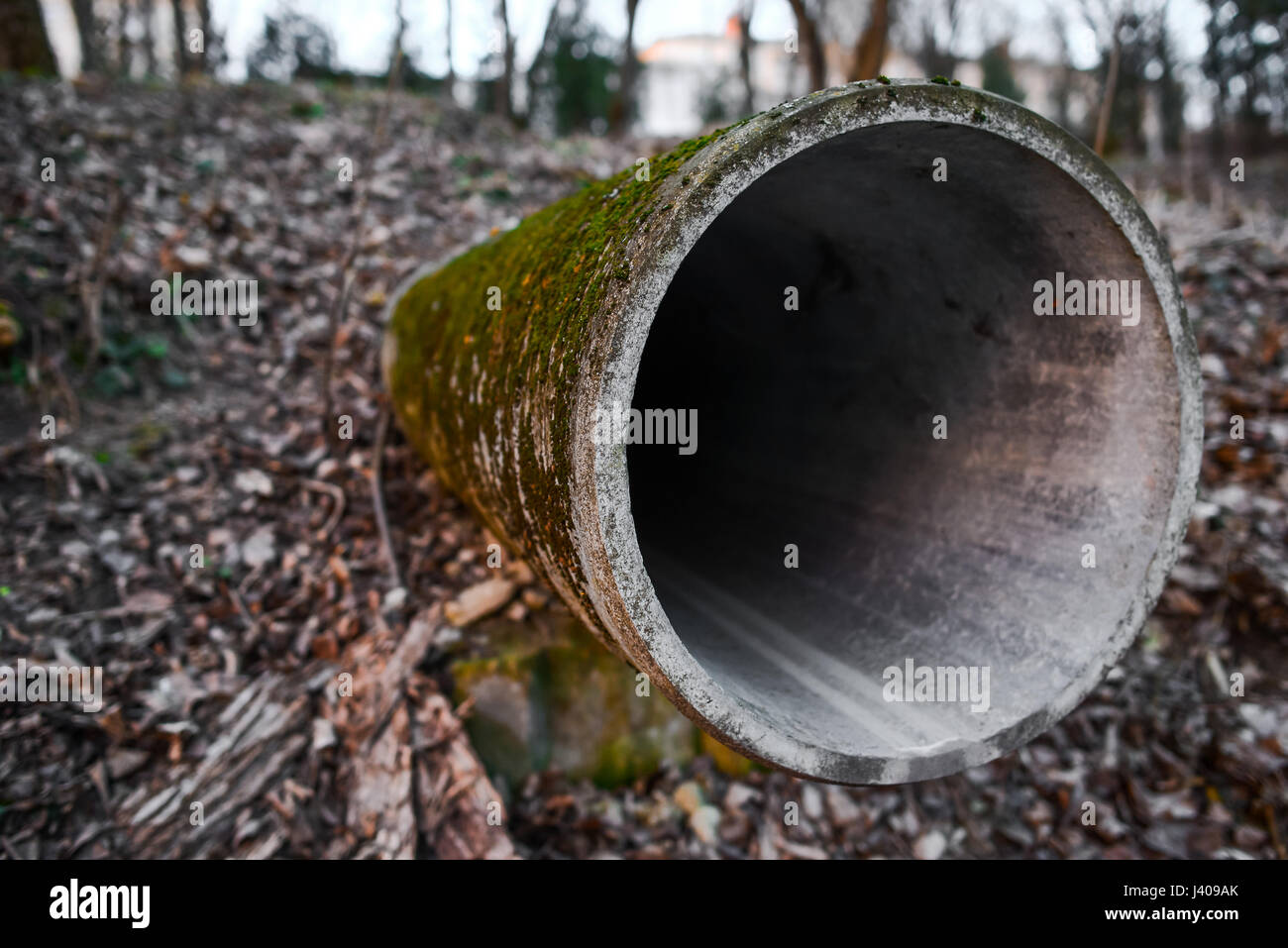 sewage pipe acts on the ground, background Stock Photo - Alamy