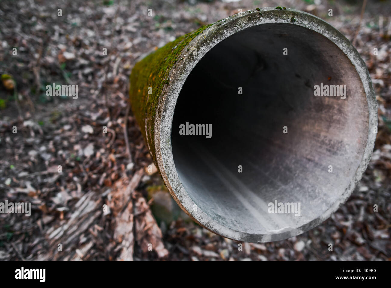 sewage pipe acts on the ground, background Stock Photo - Alamy