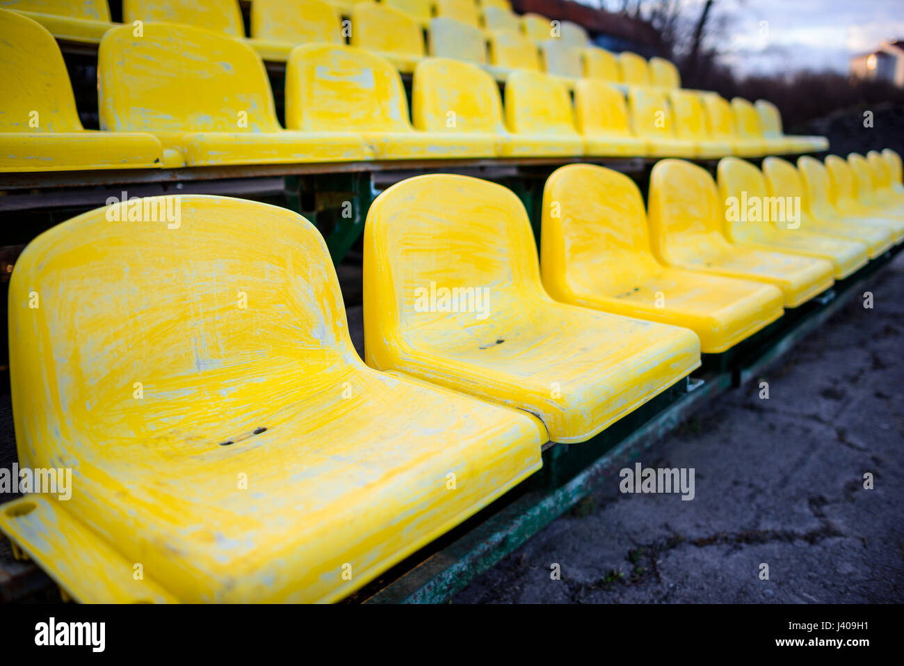 old yellow seat in stadium closeup, background Stock Photo - Alamy