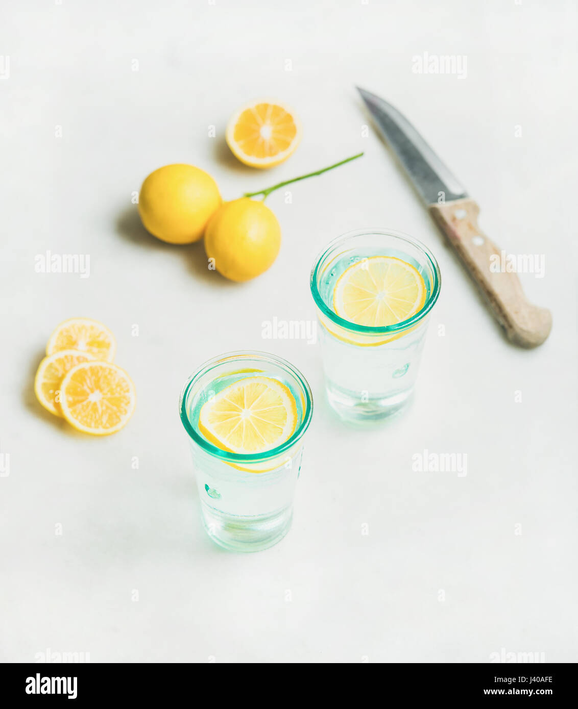 Morning detox lemon water in glasses over marble background Stock Photo ...