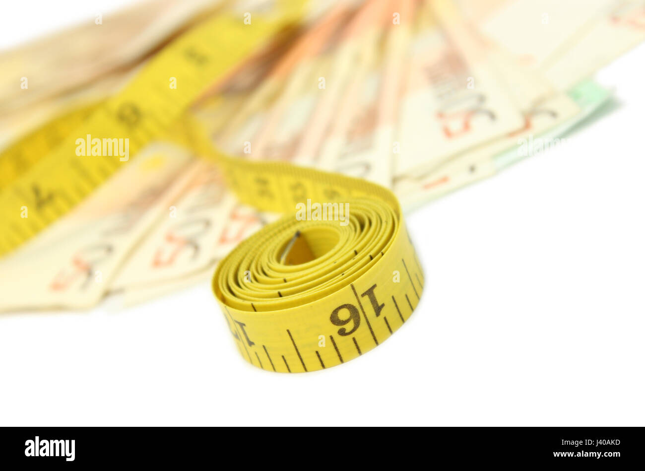 Measure tape and money Stock Photo - Alamy
