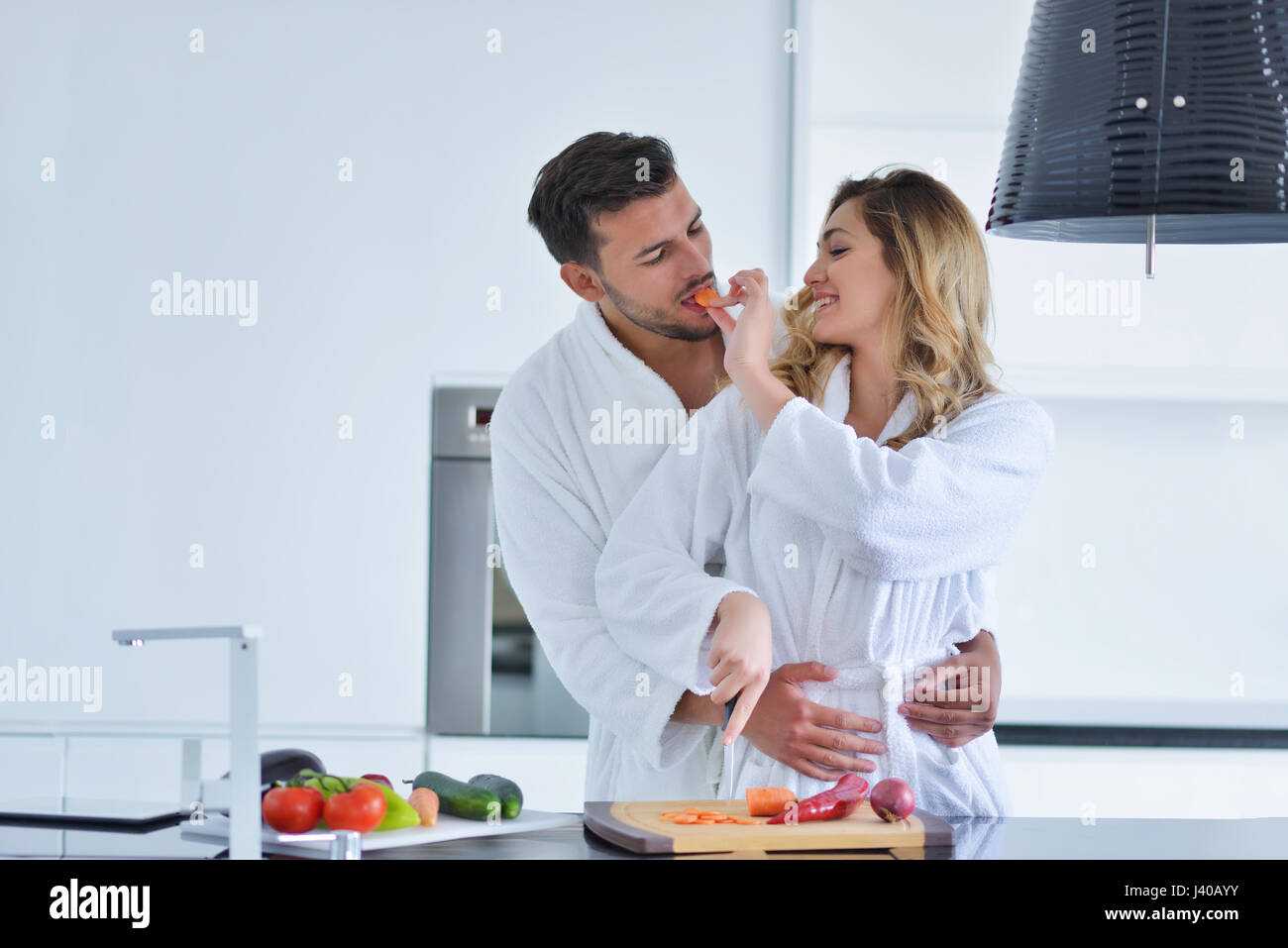 Happy couple cooking breakfast together in the kitchen Stock Photo - Alamy