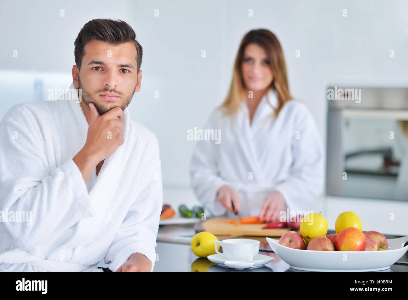 Happy couple cooking breakfast together in the kitchen Stock Photo - Alamy