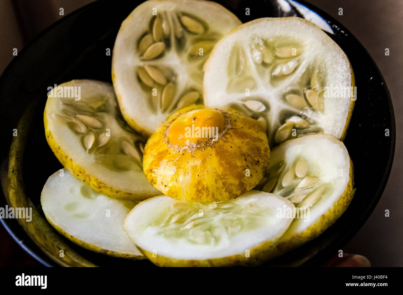 Macro closeup of sliced yellow lemon cucumber with seeds Stock Photo ...