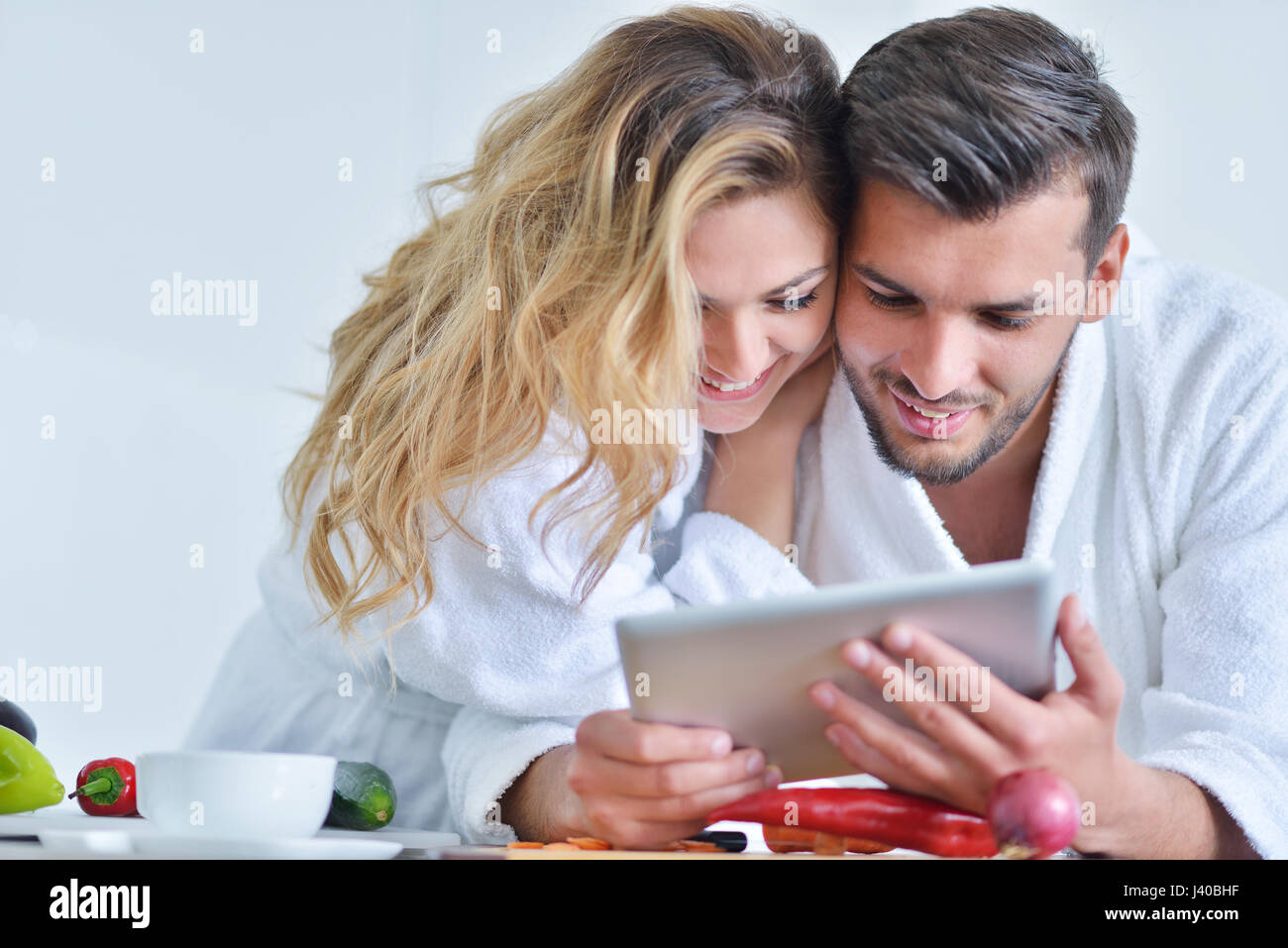 Happy couple cooking breakfast together in the kitchen Stock Photo - Alamy