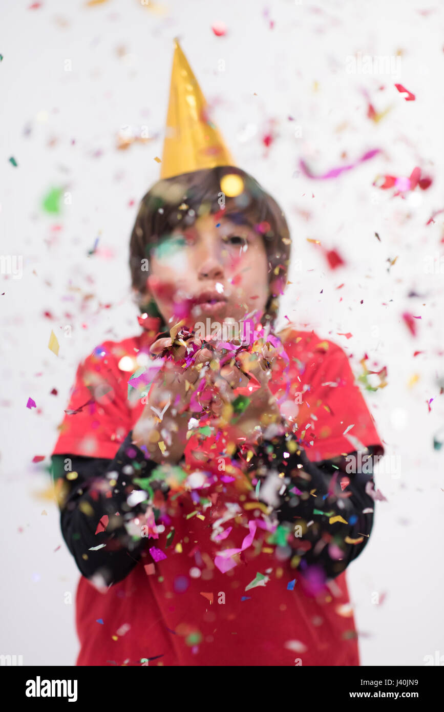 Happy kid celebrating party with blowing confetti Stock Photo - Alamy