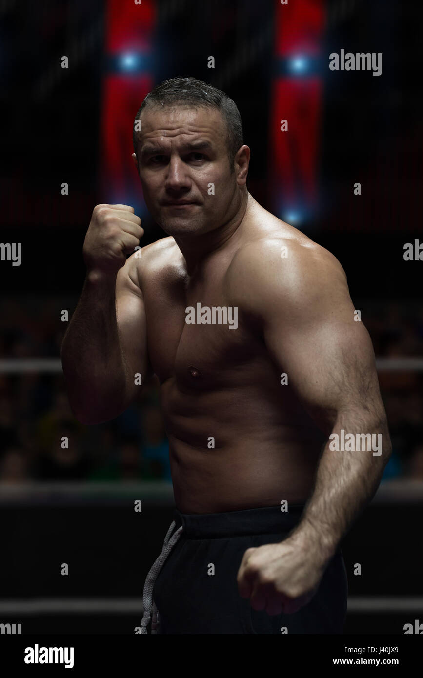 professional kickboxer with hands in martial arts position training for ...