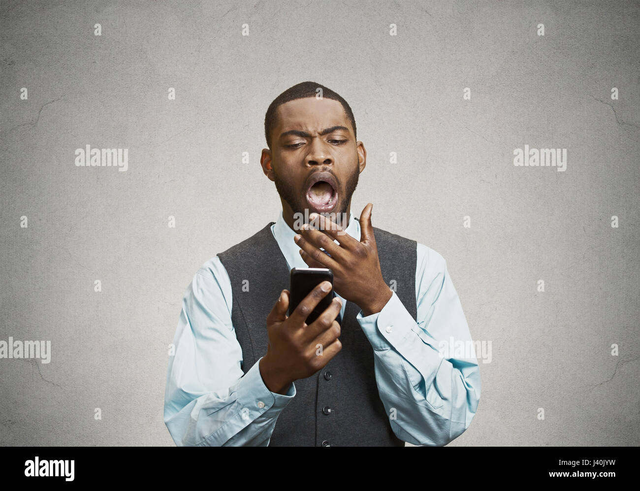 Closeup portrait sleepy young business man, funny guy hand on mouth ...