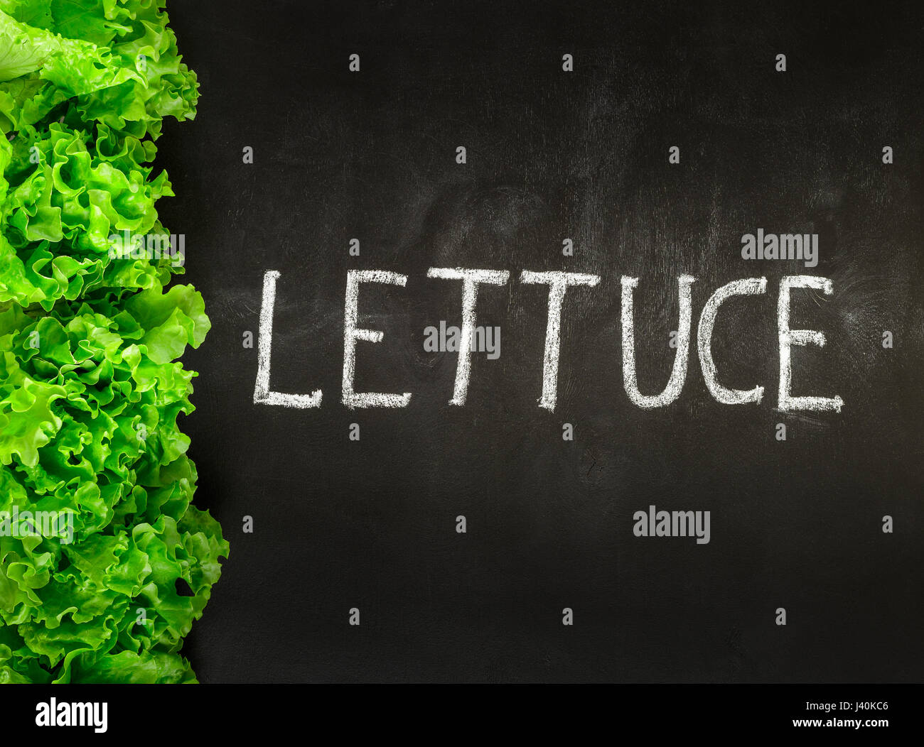 Fresh lettuce leaves border and word lettuce written on chalk black ...