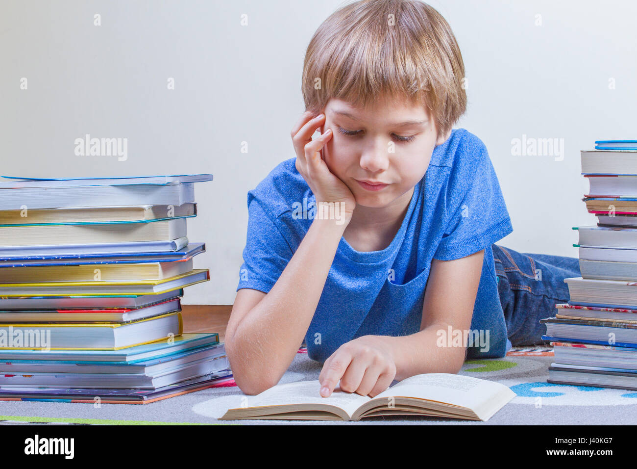 Child reading book between the stacks of books. Education, back to ...