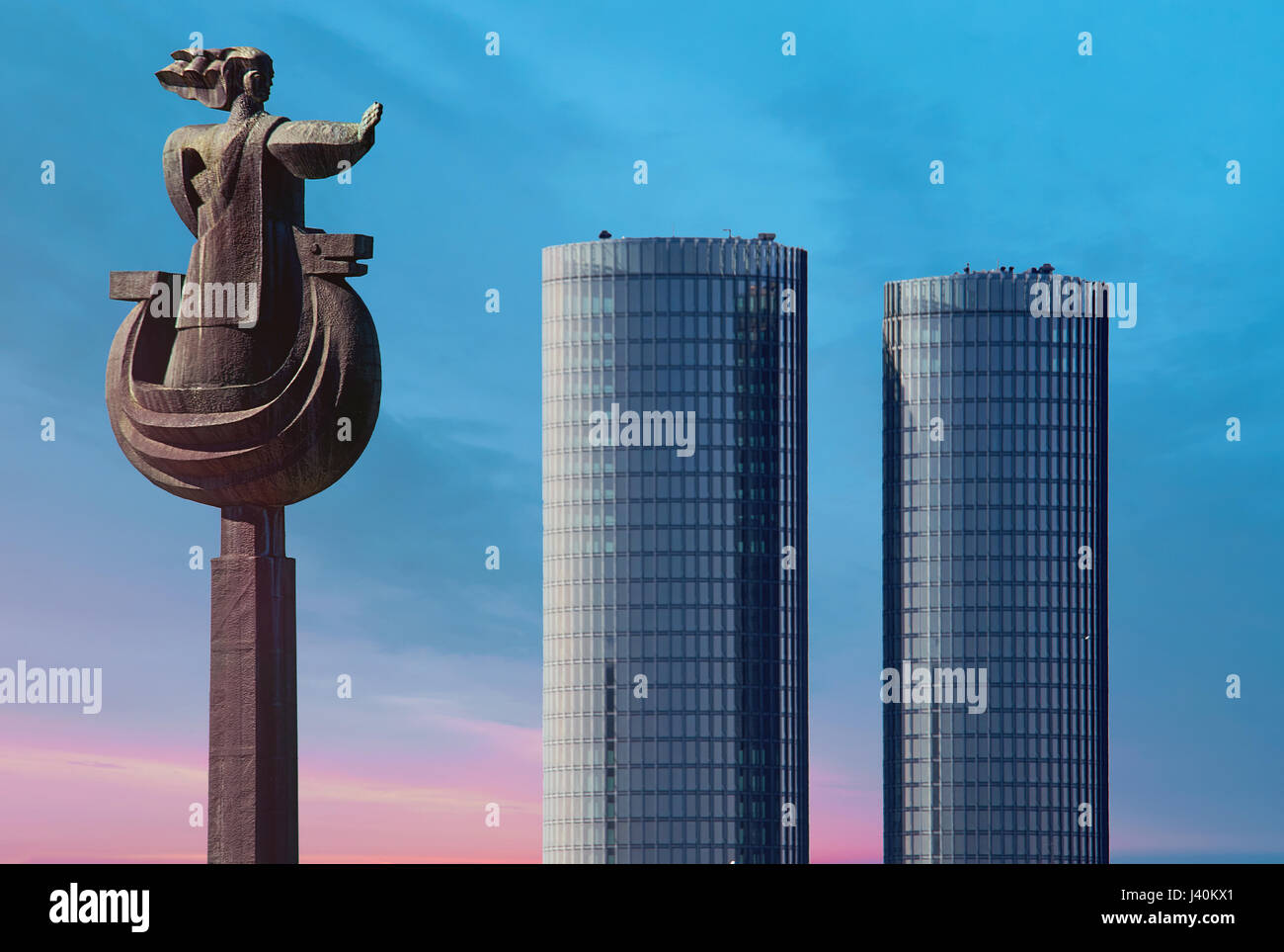 Sculpture of Daugava and view to the Modern glass skyscrapers. Two ...