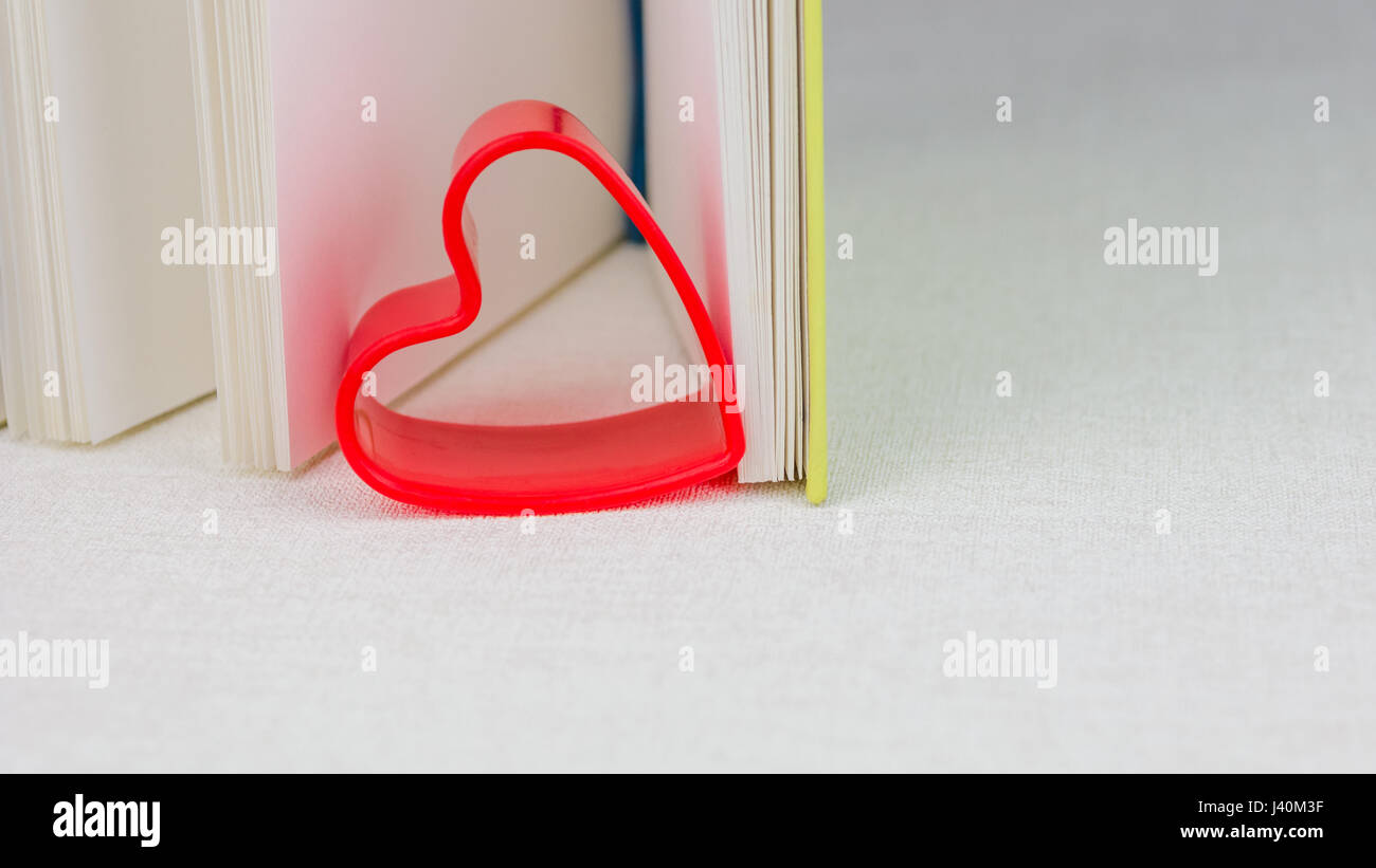 Heart between book page hi-res stock photography and images - Alamy