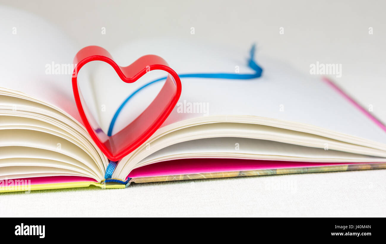 Red heart over diary book with bookmark on white table Stock Photo - Alamy