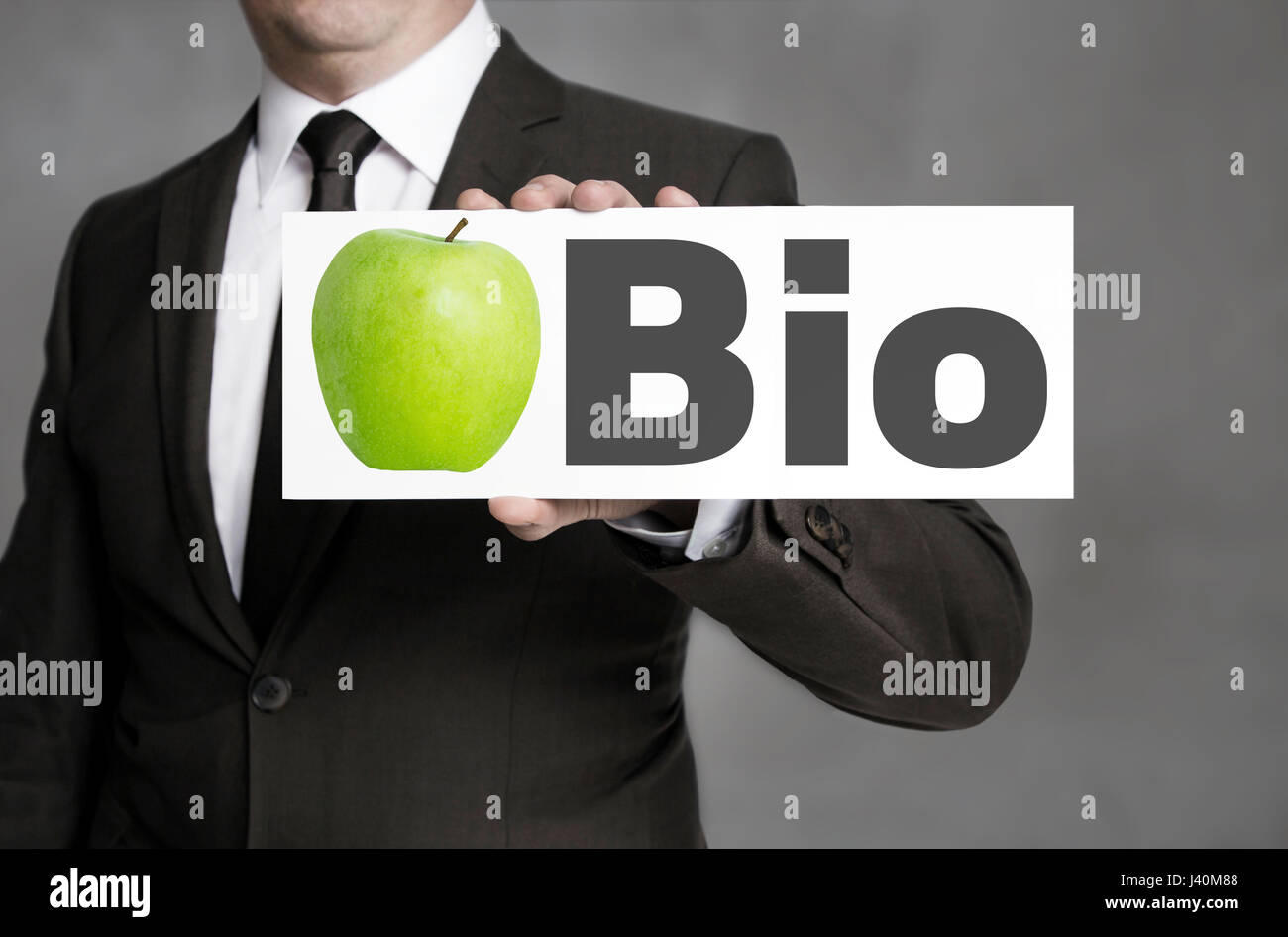 Apple Bio (in german organic) Sign is held by businessman Stock Photo ...