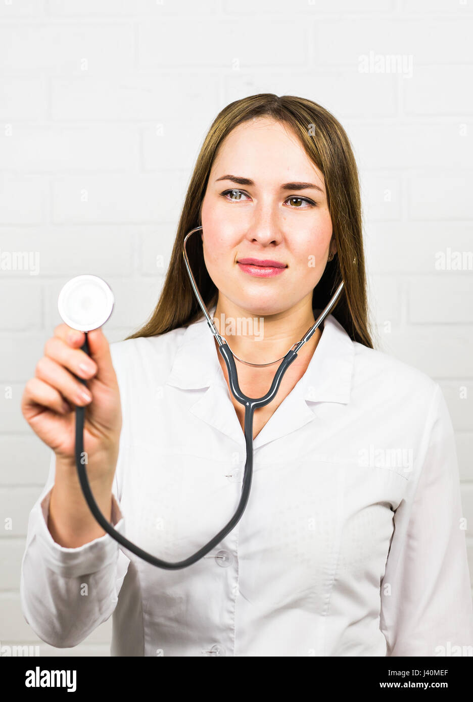 Woman doctor using stethoscope Stock Photo - Alamy
