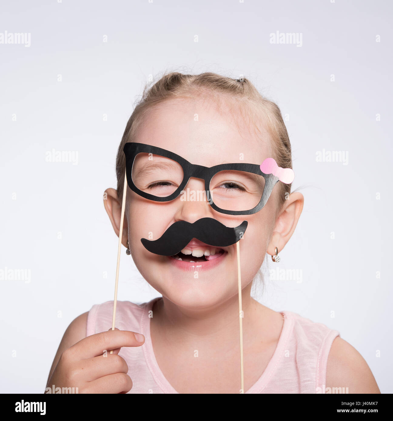 little happy girl with a mustache and glasses Stock Photo - Alamy