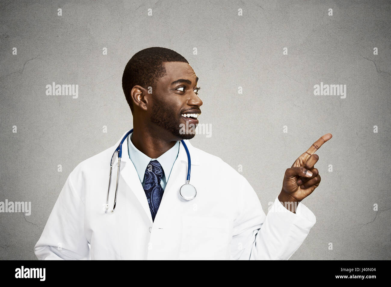 Closeup portrait smiling, happy doctor, pharmacist, dentist pointing ...