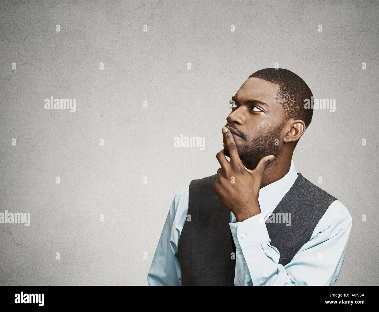 Side view portrait young, puzzled business man thinking, deciding about ...