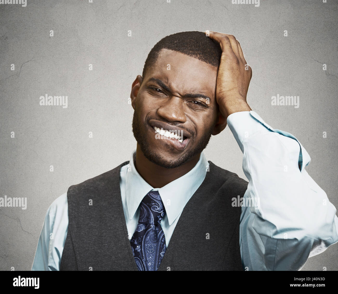portrait of desperate man, isolated on grey wall background. Negative ...