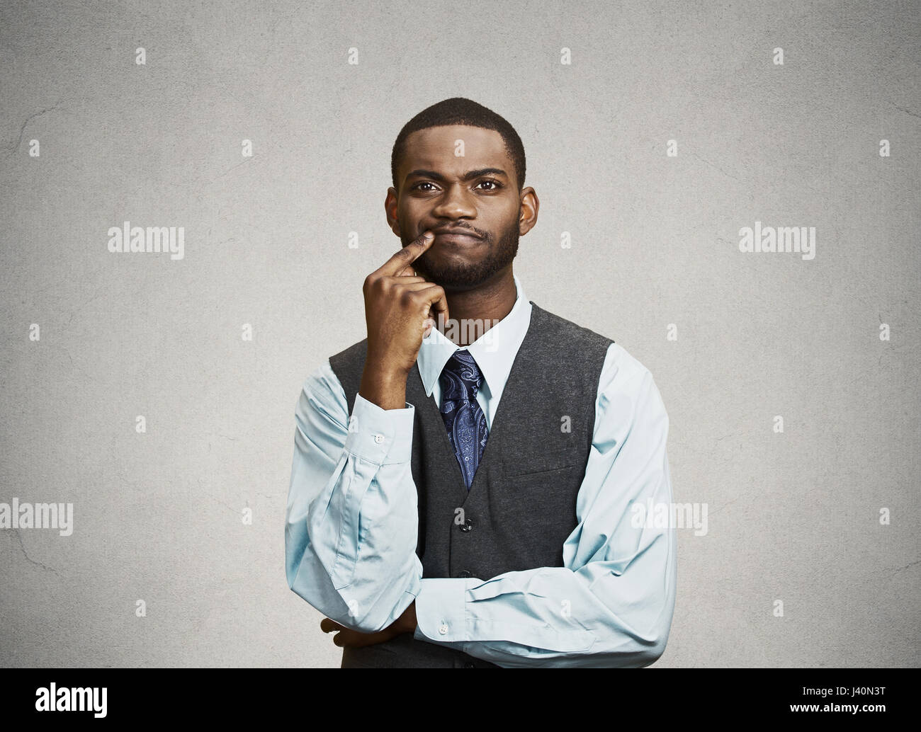 Closeup portrait young, puzzled business man thinking, deciding deeply ...