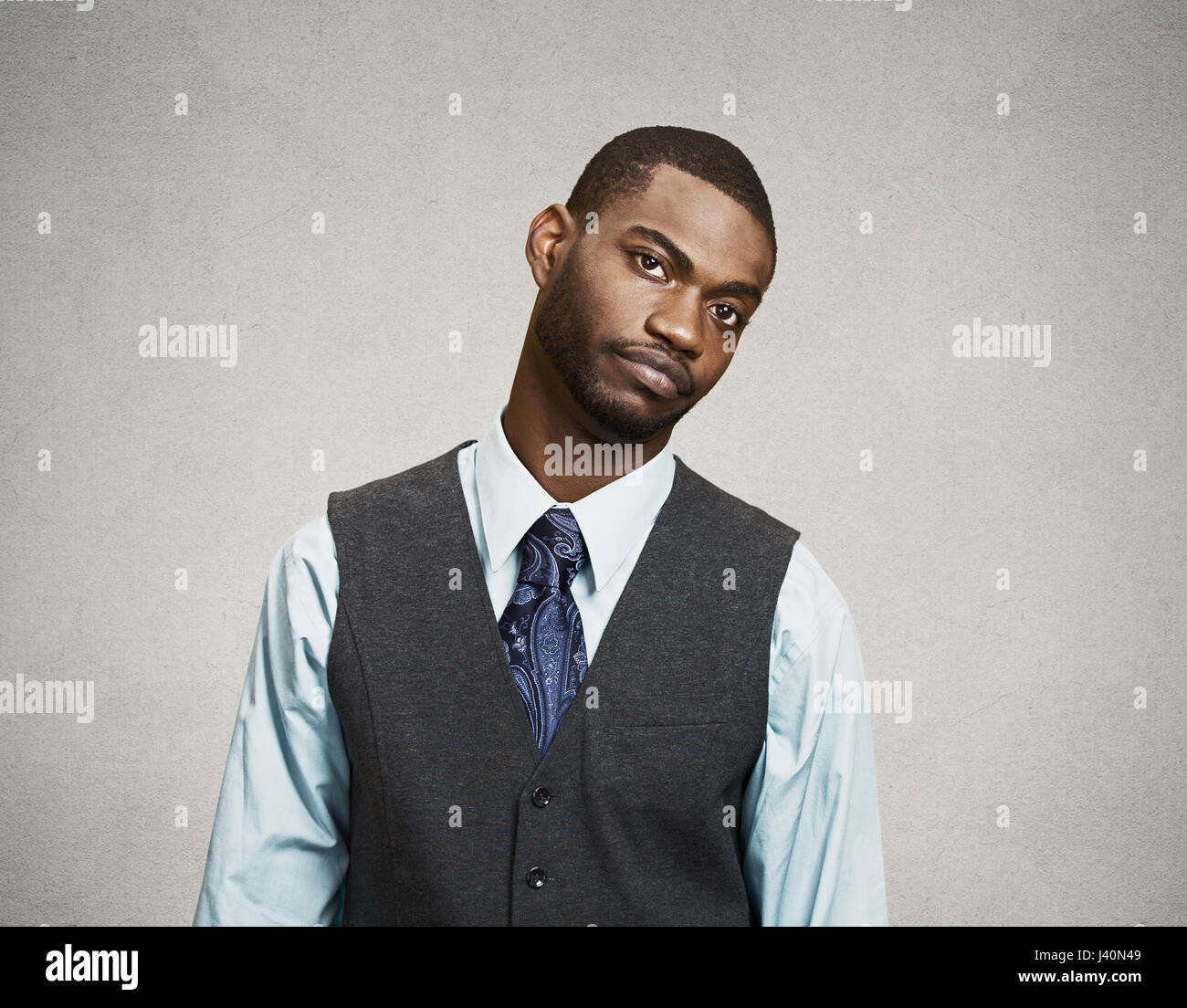 Business man with annoyed face expression, isolated grey wall ...