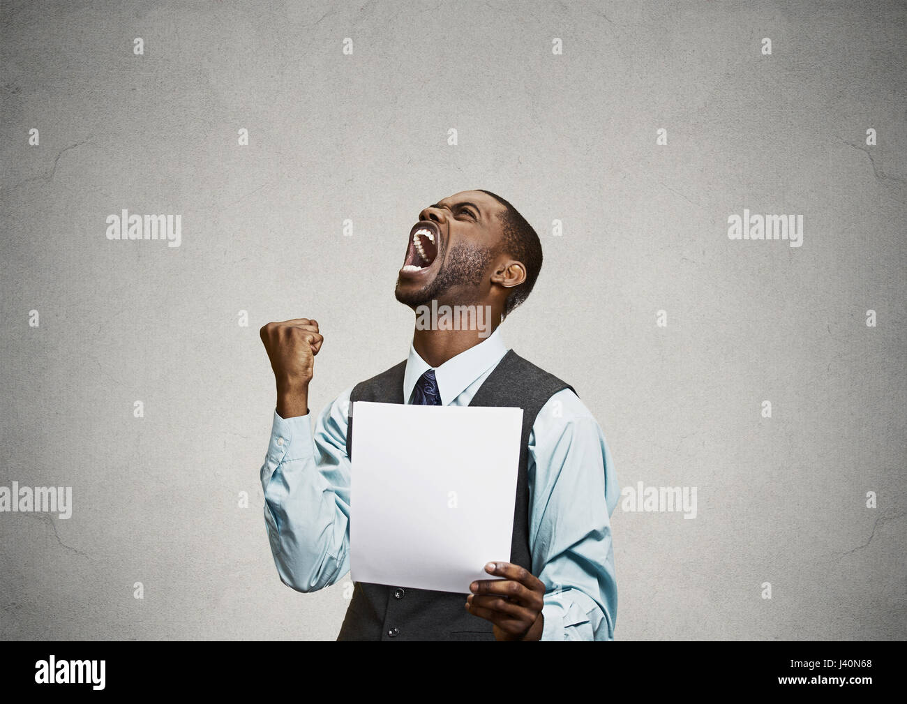 Closeup portrait angry, mad, screaming business man holding paper ...